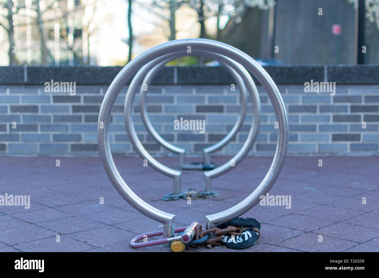 Old bike locks on some empty bicycle stands in New York City Stock ...