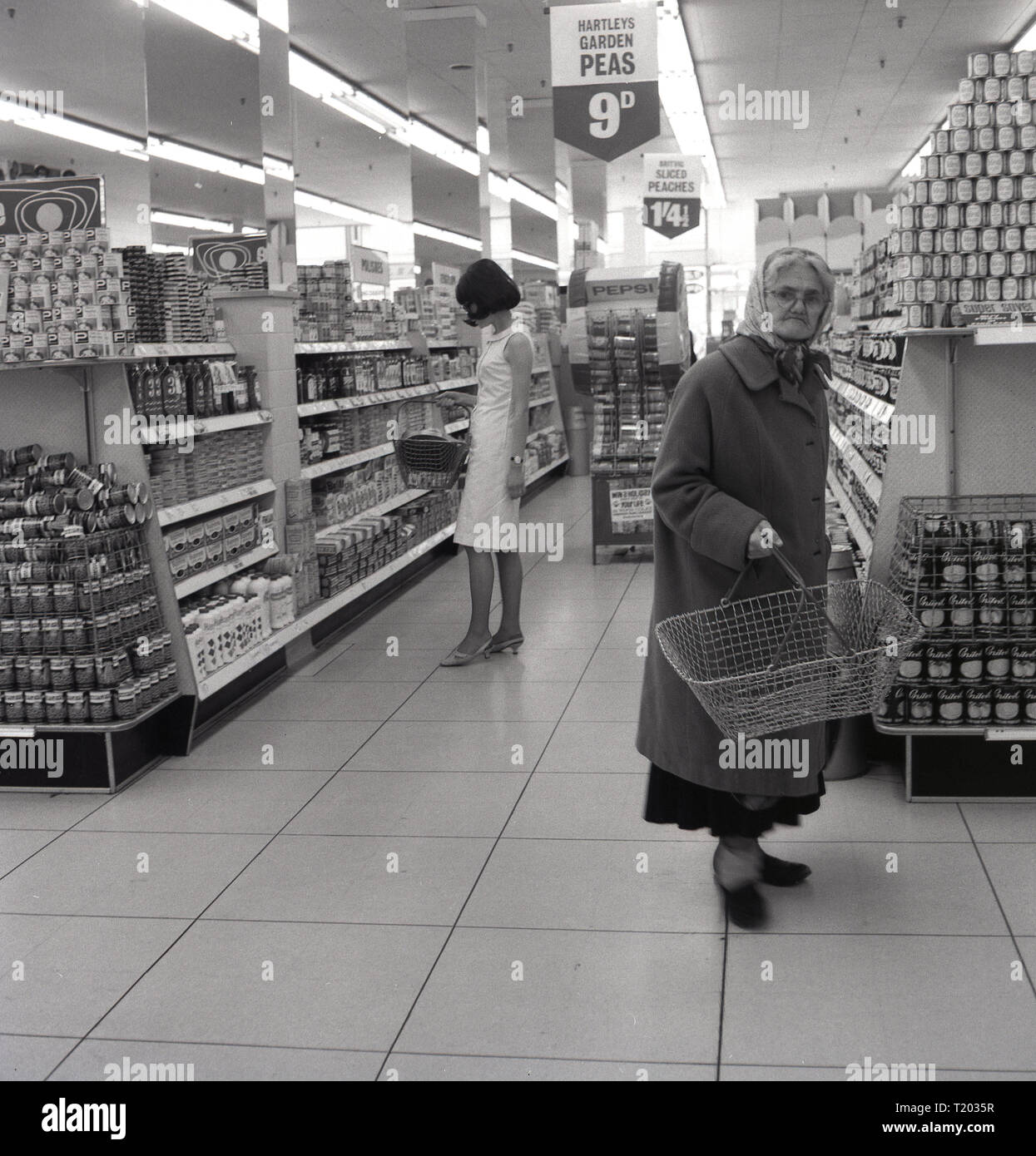 1960s, a female shopper with a shopping basket in a new 'Finefare ...