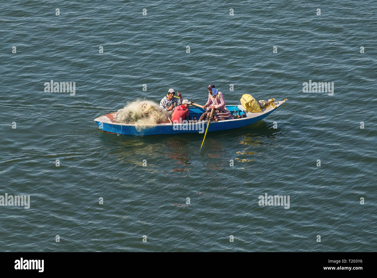 Ismailia, Egypt - November 5, 2017: Fishermen in wooden boat catch fish ...