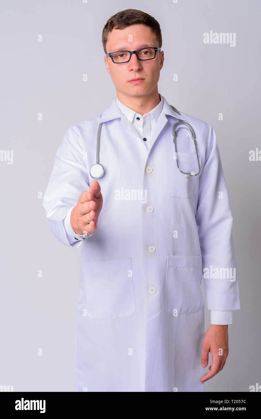 Portrait of young man doctor giving handshake Stock Photo - Alamy