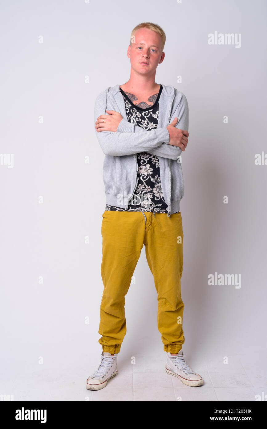 Full body shot of young man wearing stylish clothes with arms crossed ...