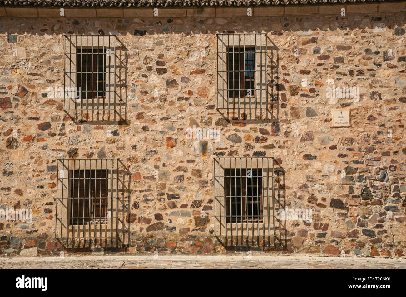 Medieval building facade with barred windows at Caceres. A charming ...