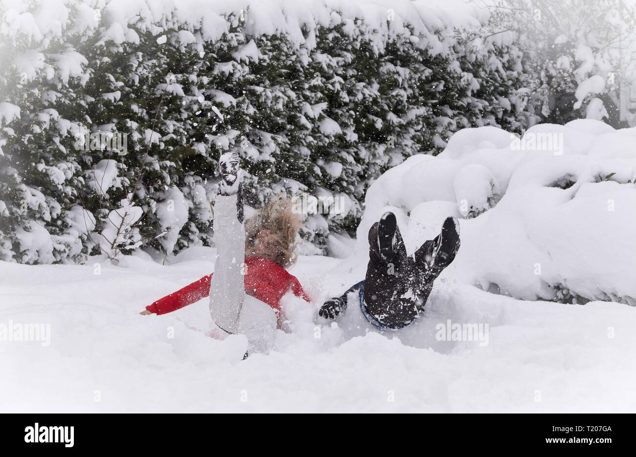 Mother and child jumping in deep snow, having fun Stock Photo - Alamy