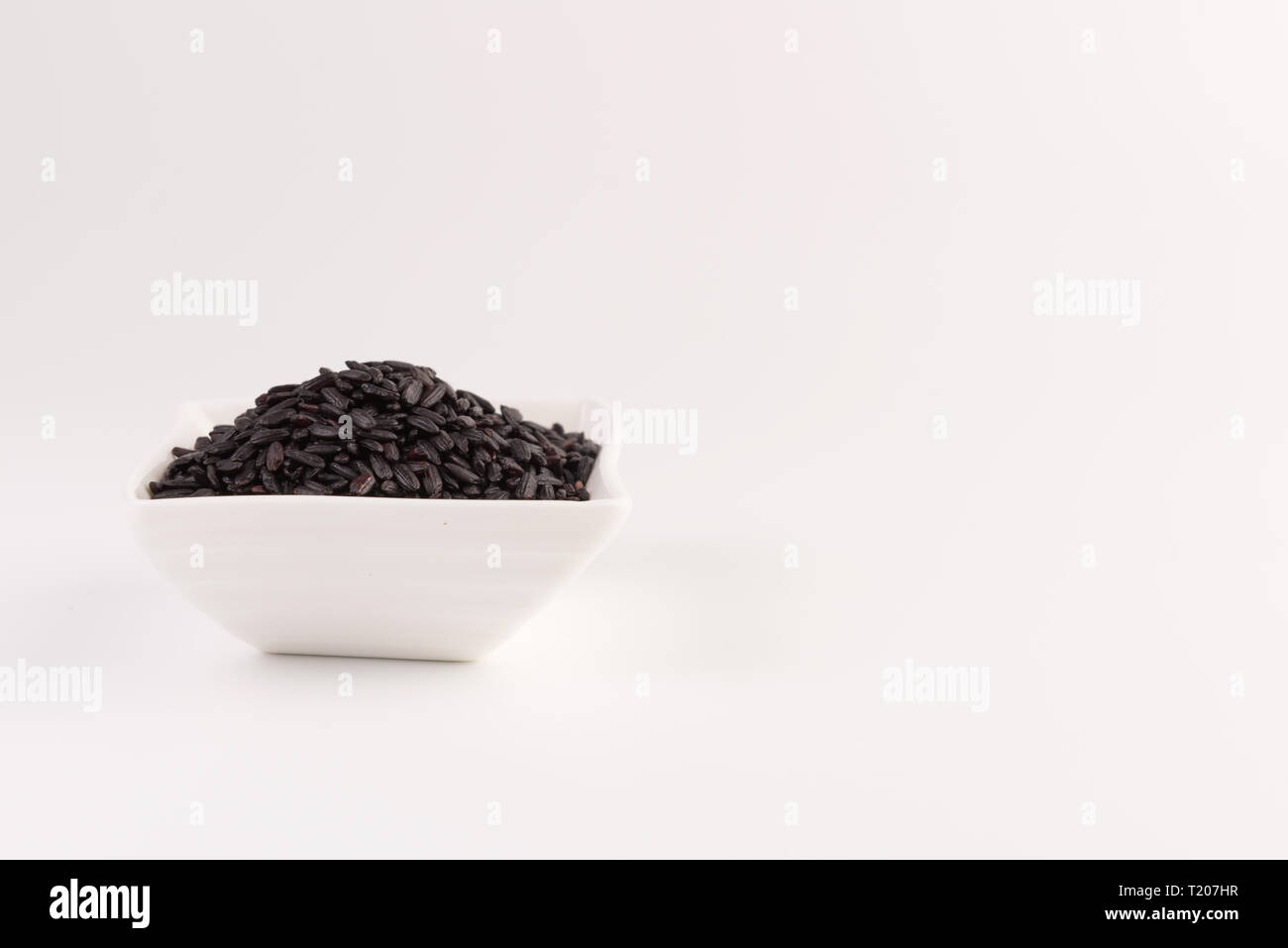bowl of black wild rice isolated on white background Stock Photo - Alamy