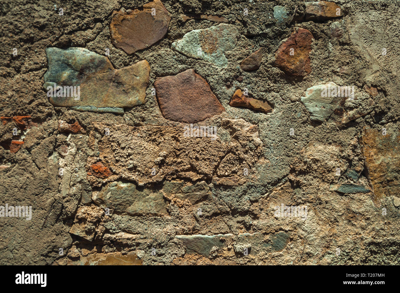 Wall made of rough stones forming a singular background at Caceres. A ...
