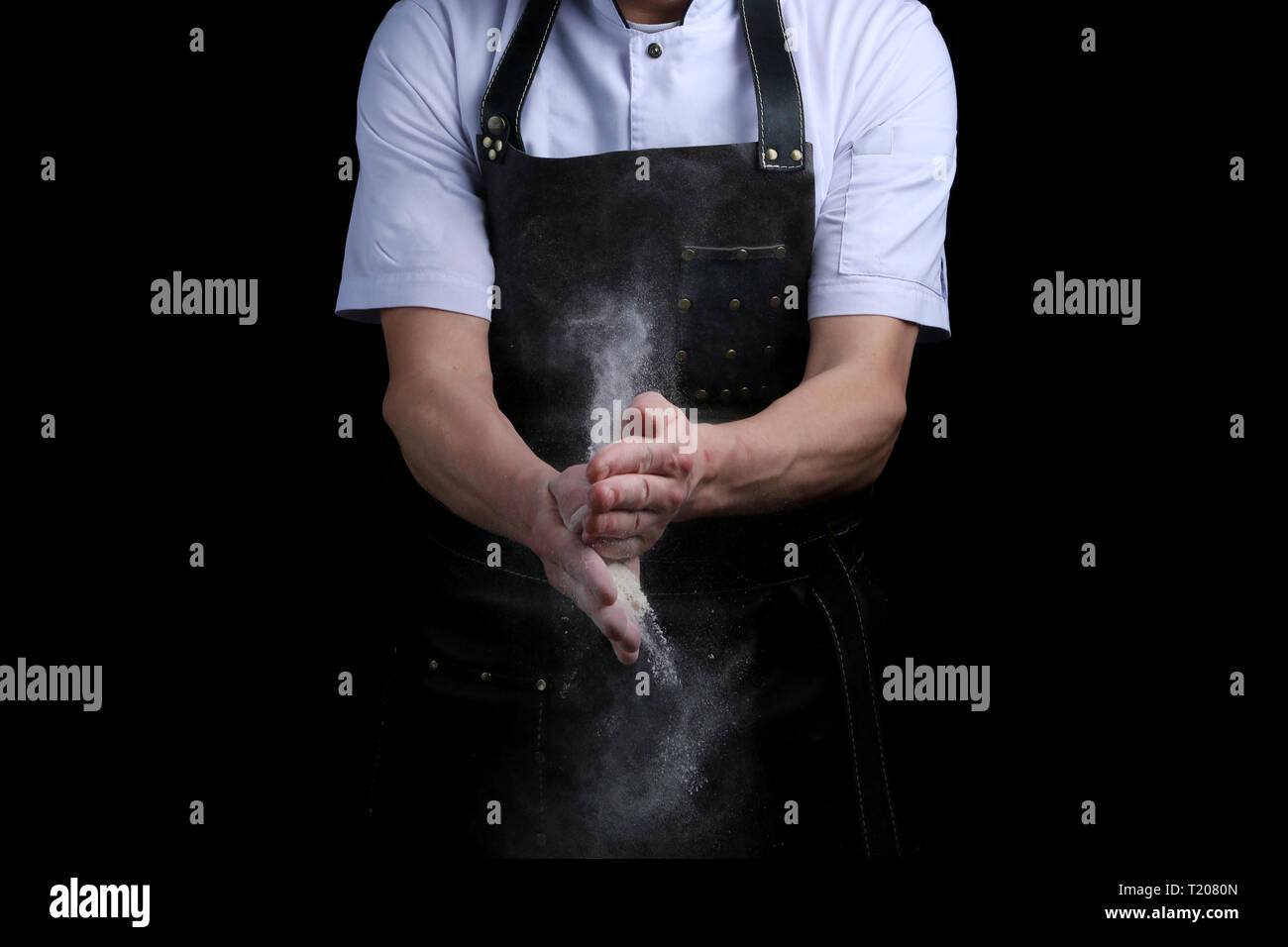 Chef hands in flour on black back. clap with flour. baking bread and ...