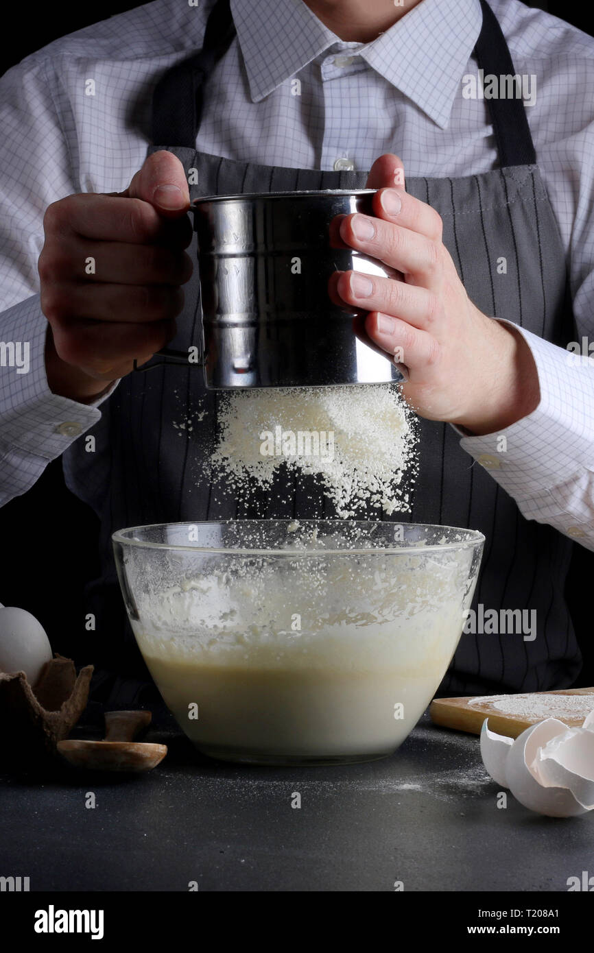 Bakery man sifting flour preparing hi-res stock photography and images ...