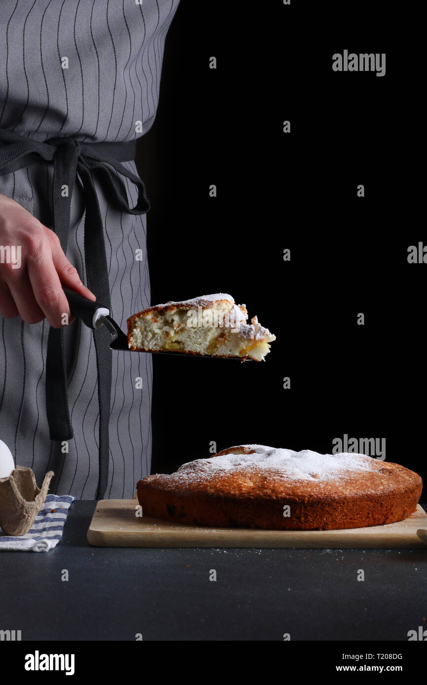chef serves the pie on dark background. pie recipe concept Stock Photo ...