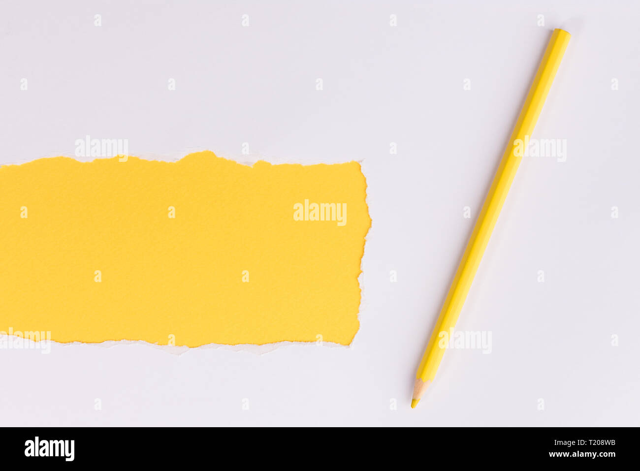 White torn paper over yellow background with pencil Stock Photo - Alamy