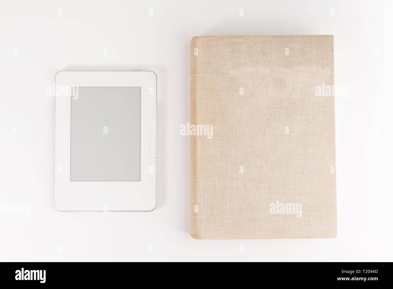 Digital e-book reader with a blank screen owith old paper book ...