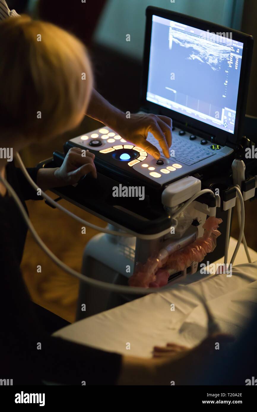 Real Sonography, ultrasonic scanning in dark room. Portable sonograph ...