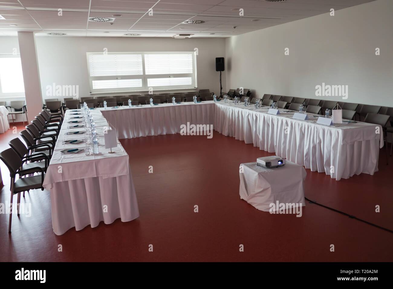 Empty congress room before seminar, bottles of mineral water on table ...