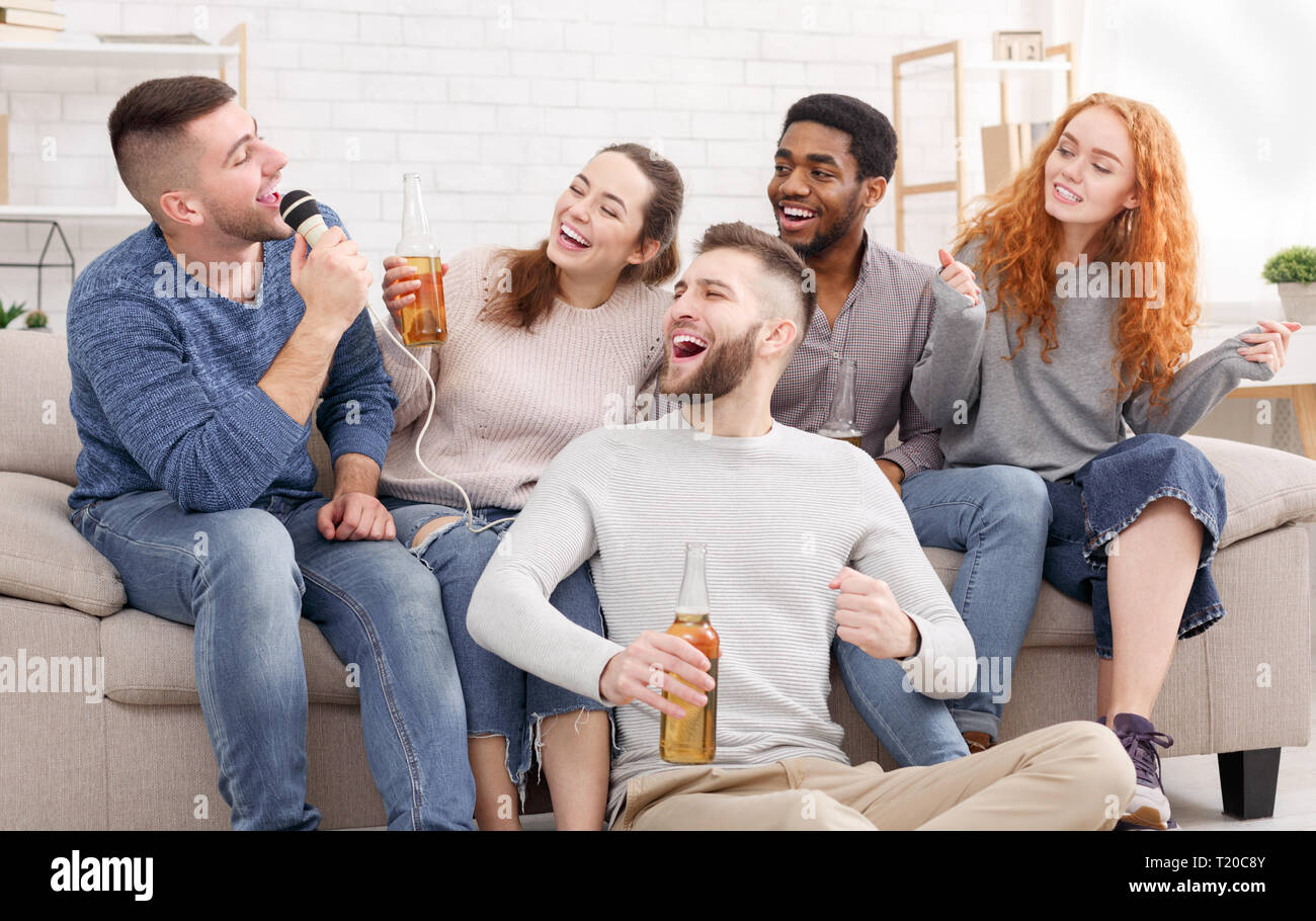 Group of friends having fun, singing songs together Stock Photo - Alamy