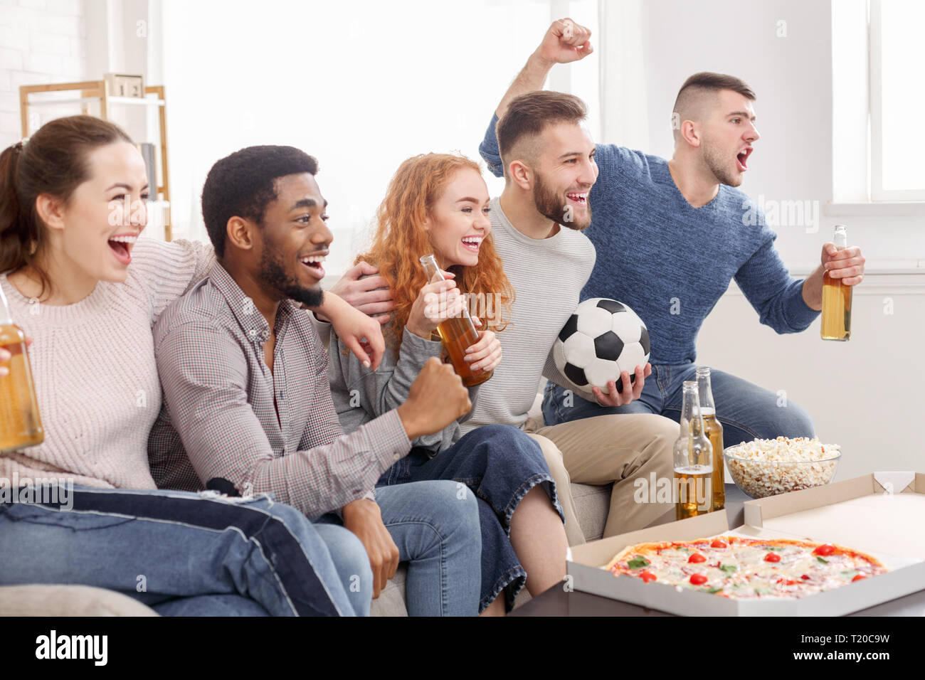 Football fans watching game and drinking beer Stock Photo - Alamy