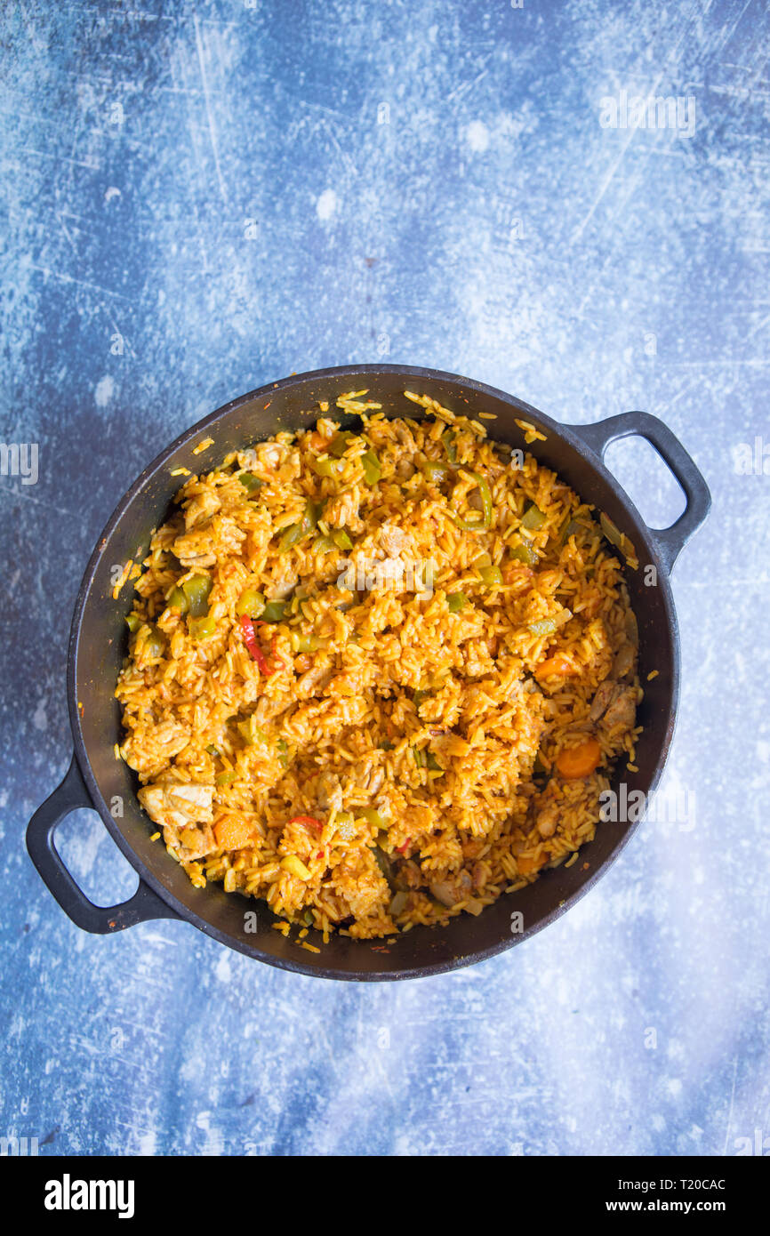 African jollof rice cooked in a dark pot. Top view african rice meal ...