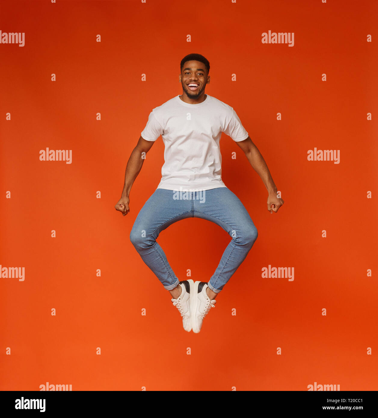 Rocket flight. Positive african american guy jumping and clapping his ...