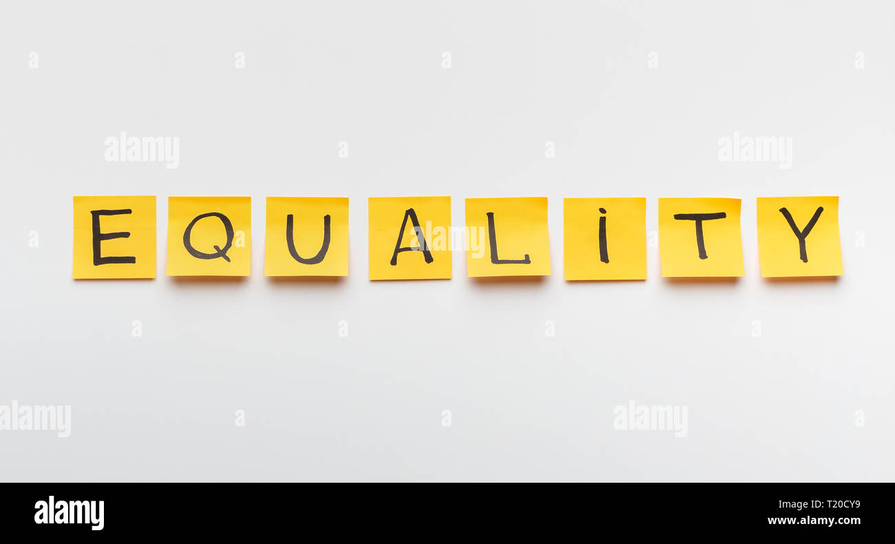Word EQUALITY written on yellow office stickers on white background ...