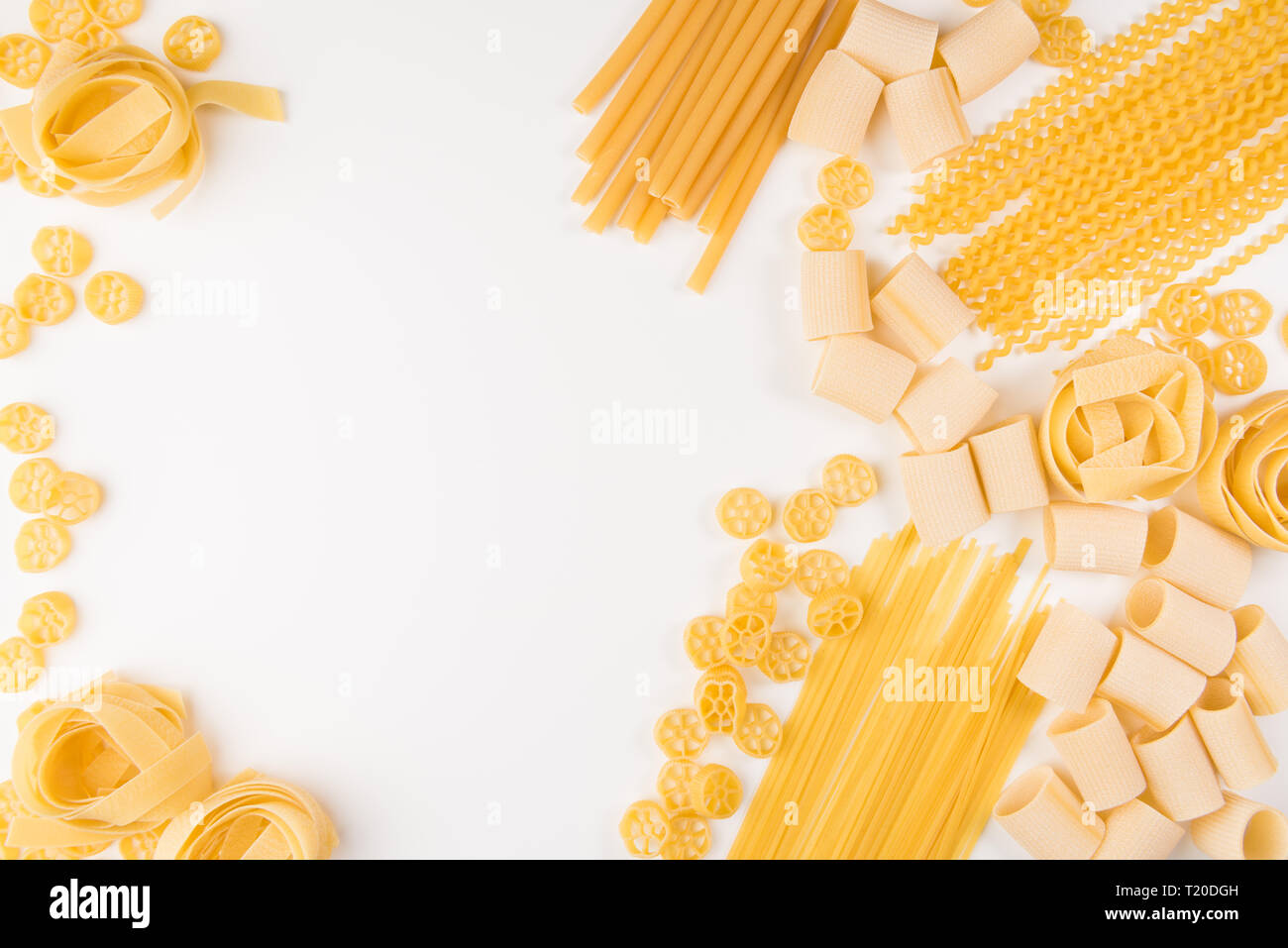 Food and drink concept - various uncooked pasta on white background ...