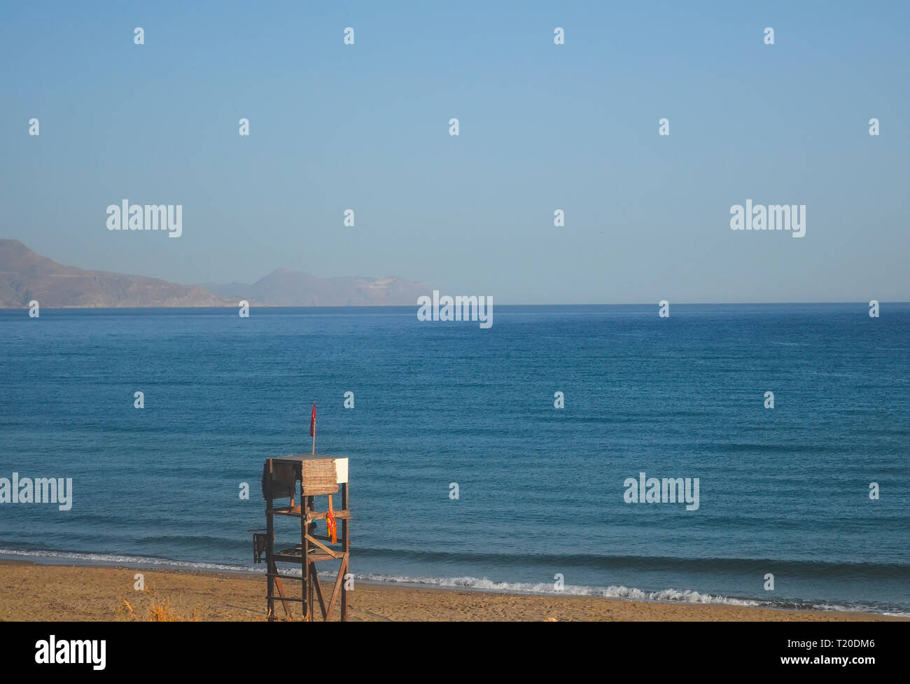 Old broken wooden lifeguard tower on an abandoned beach in the early ...