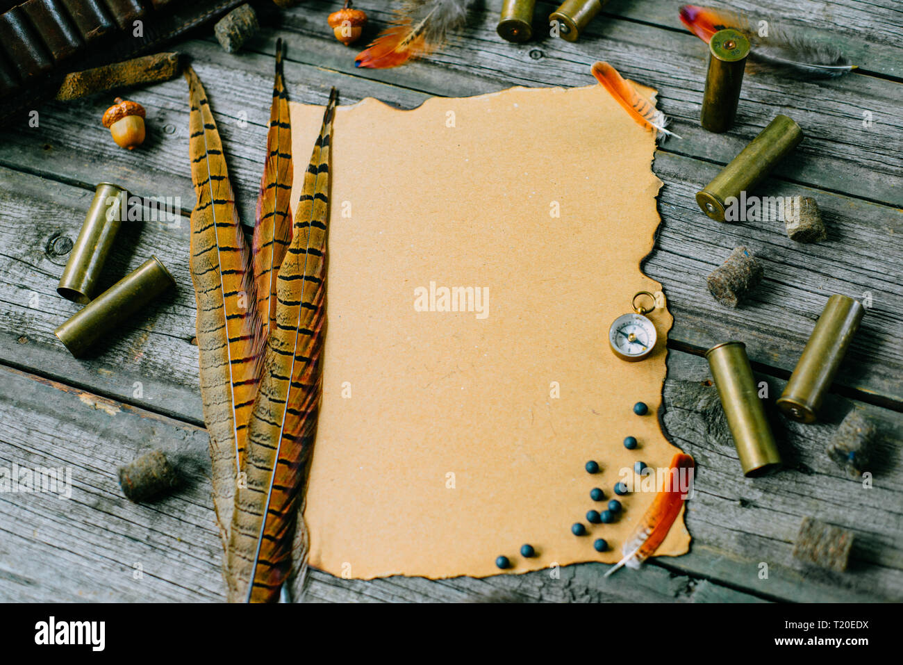 Vintage paper for information feather and cartridges on old wooden ...