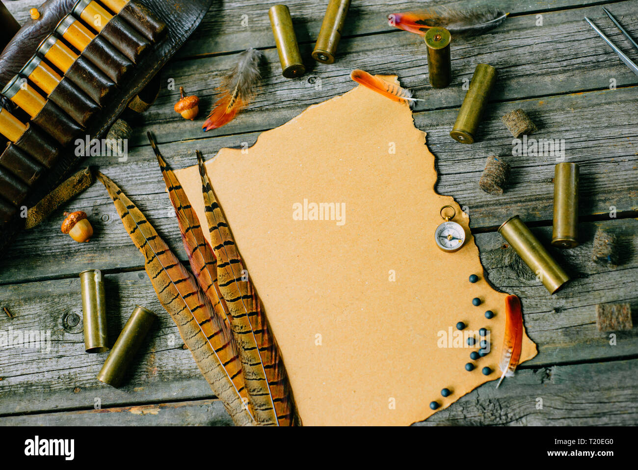 Paper for information with pheasant feather and cartridges beside on ...