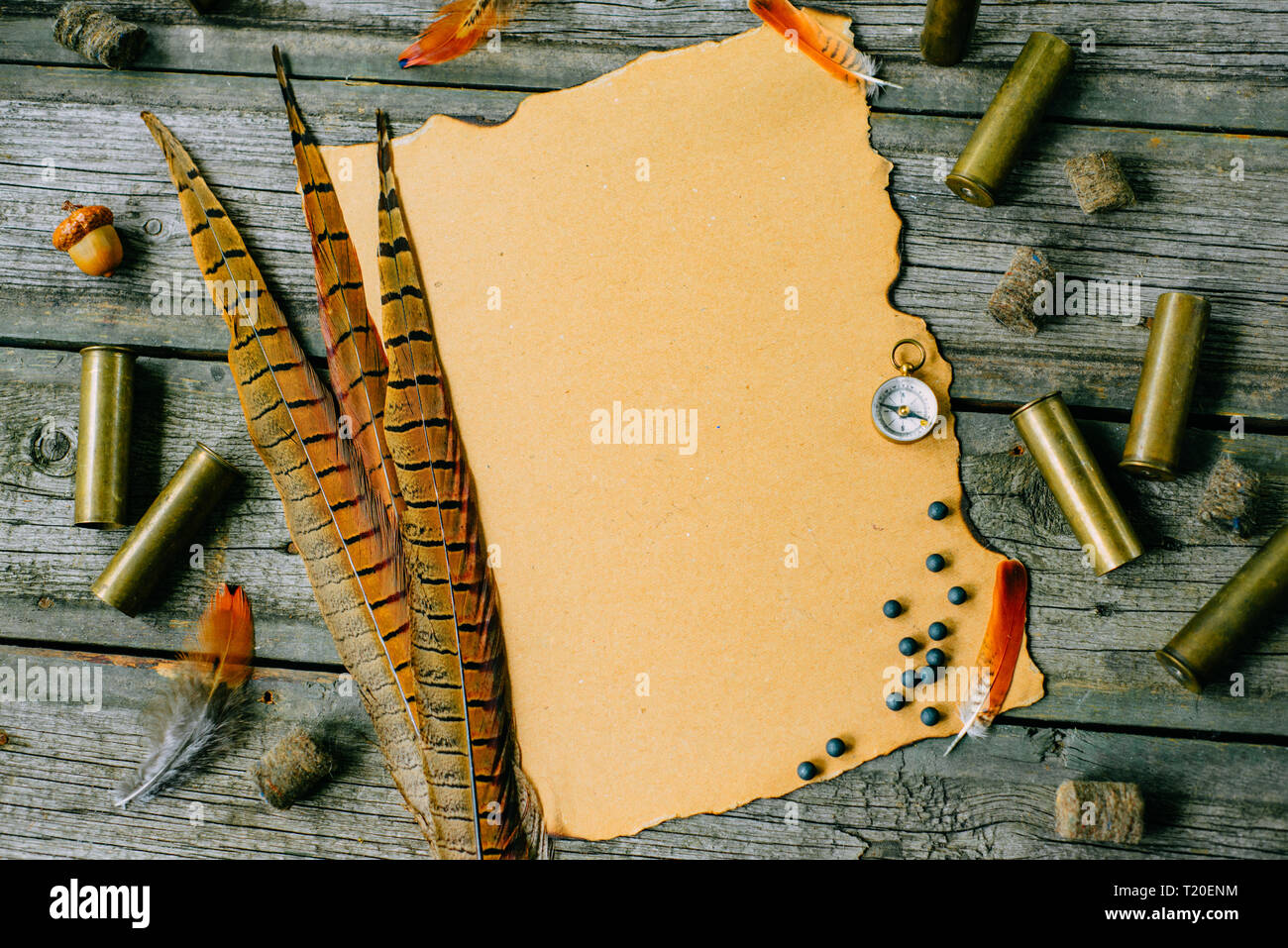 Vintage paper for information feather and cartridges on old wooden ...