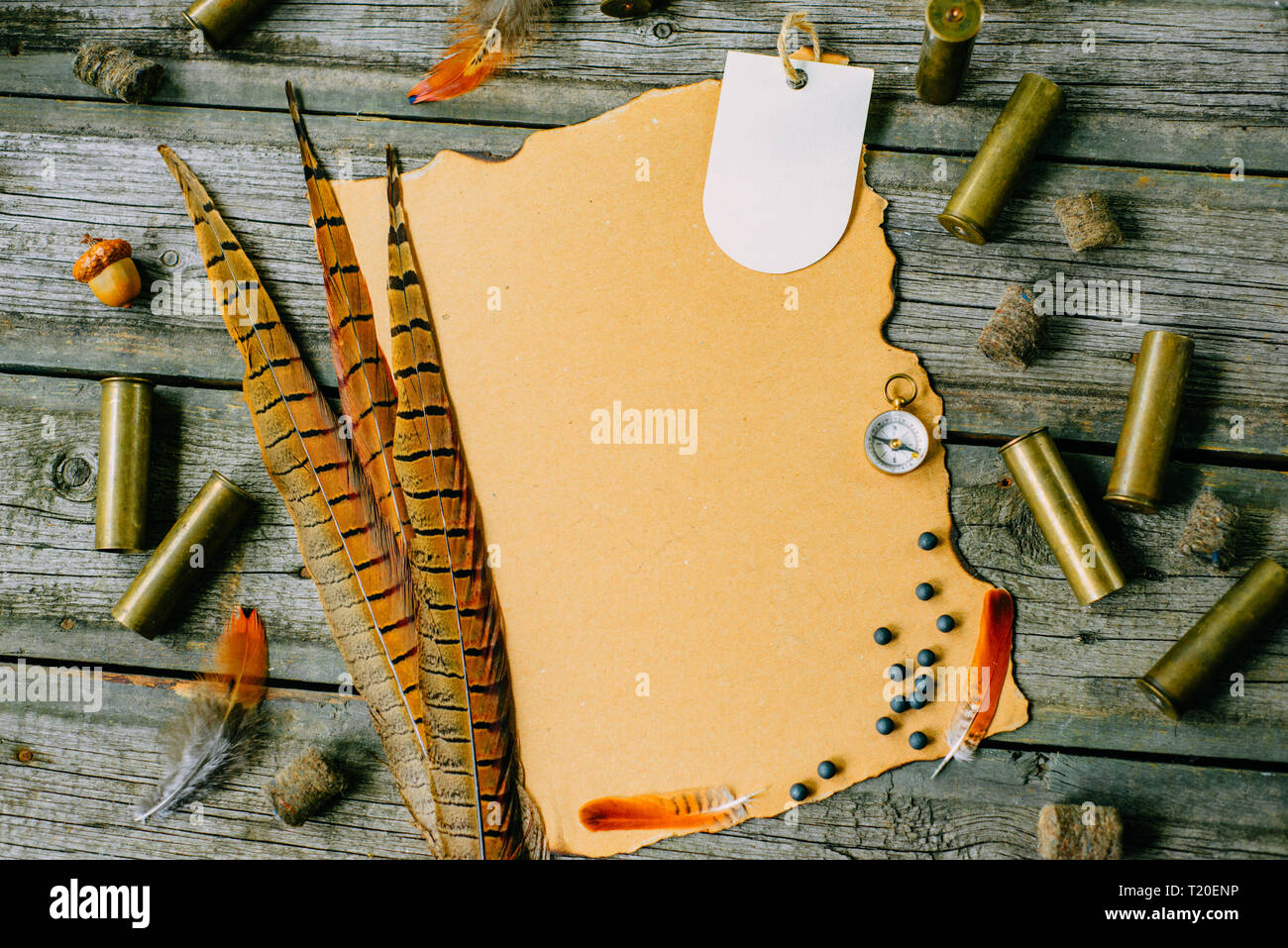 Feather and cartridges on vintage paper with label for information on ...