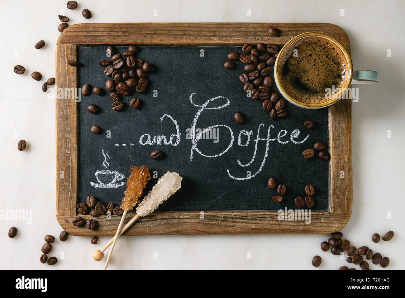 Cup of espresso coffee, sugar sticks and coffee beans on vintage ...