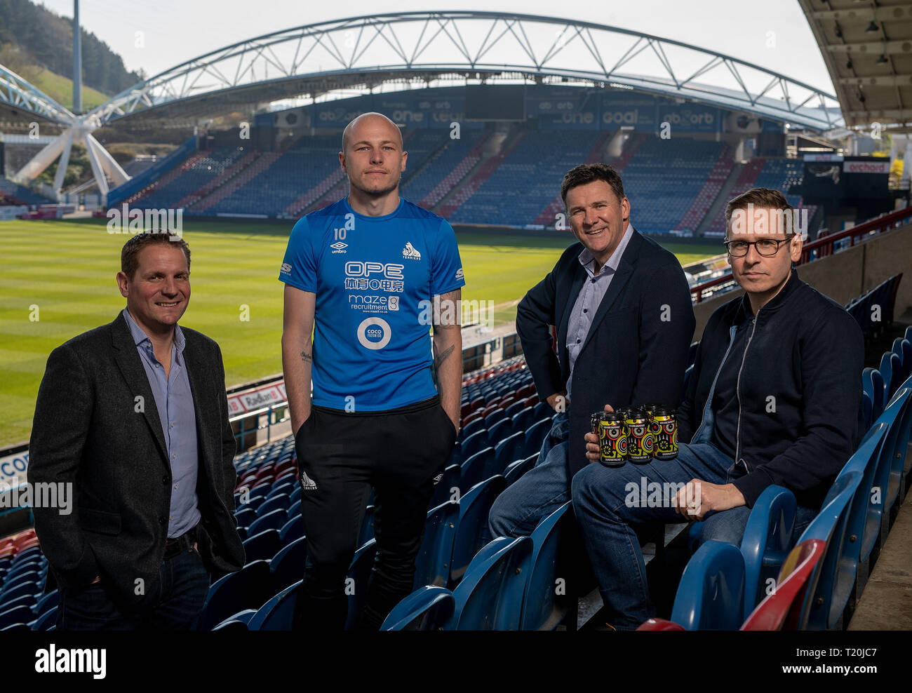Huddersfield Town's Aaron Mooy (second left) with Lion Global Markets ...