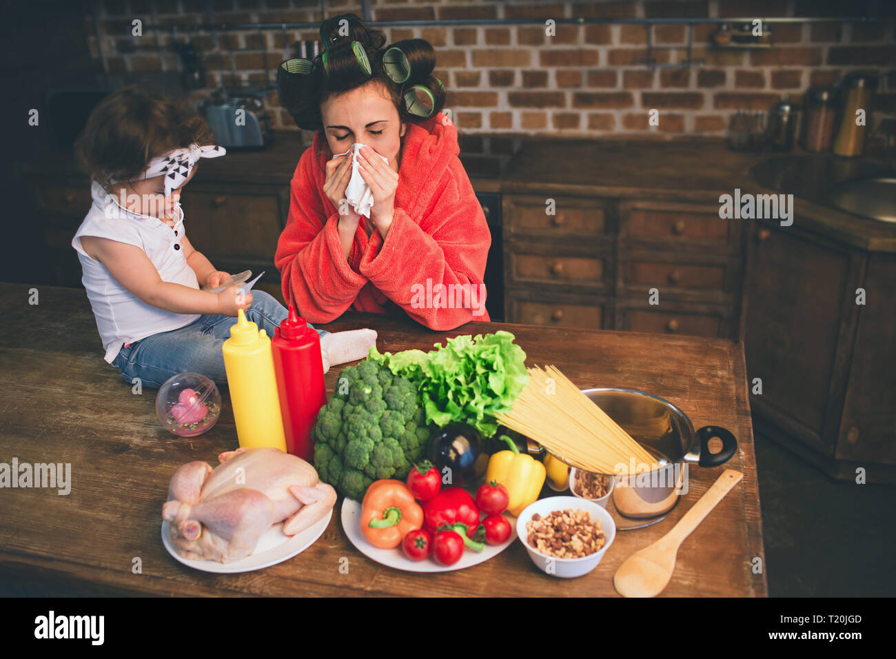 Stressed mum at home. Young mother with little child in the home ...