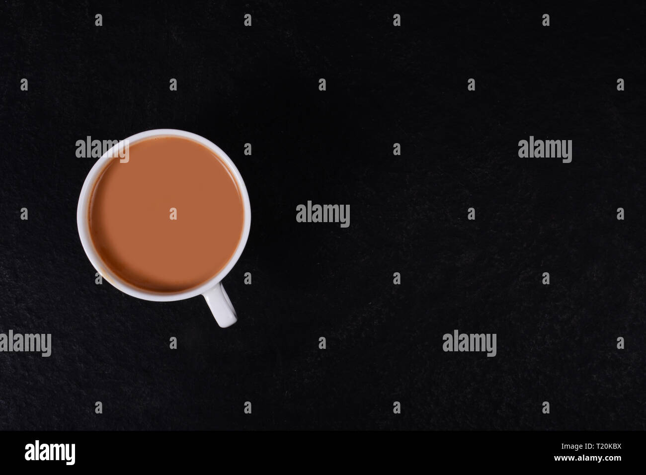 Cup of tea seen from above on a black background, Copy space available ...