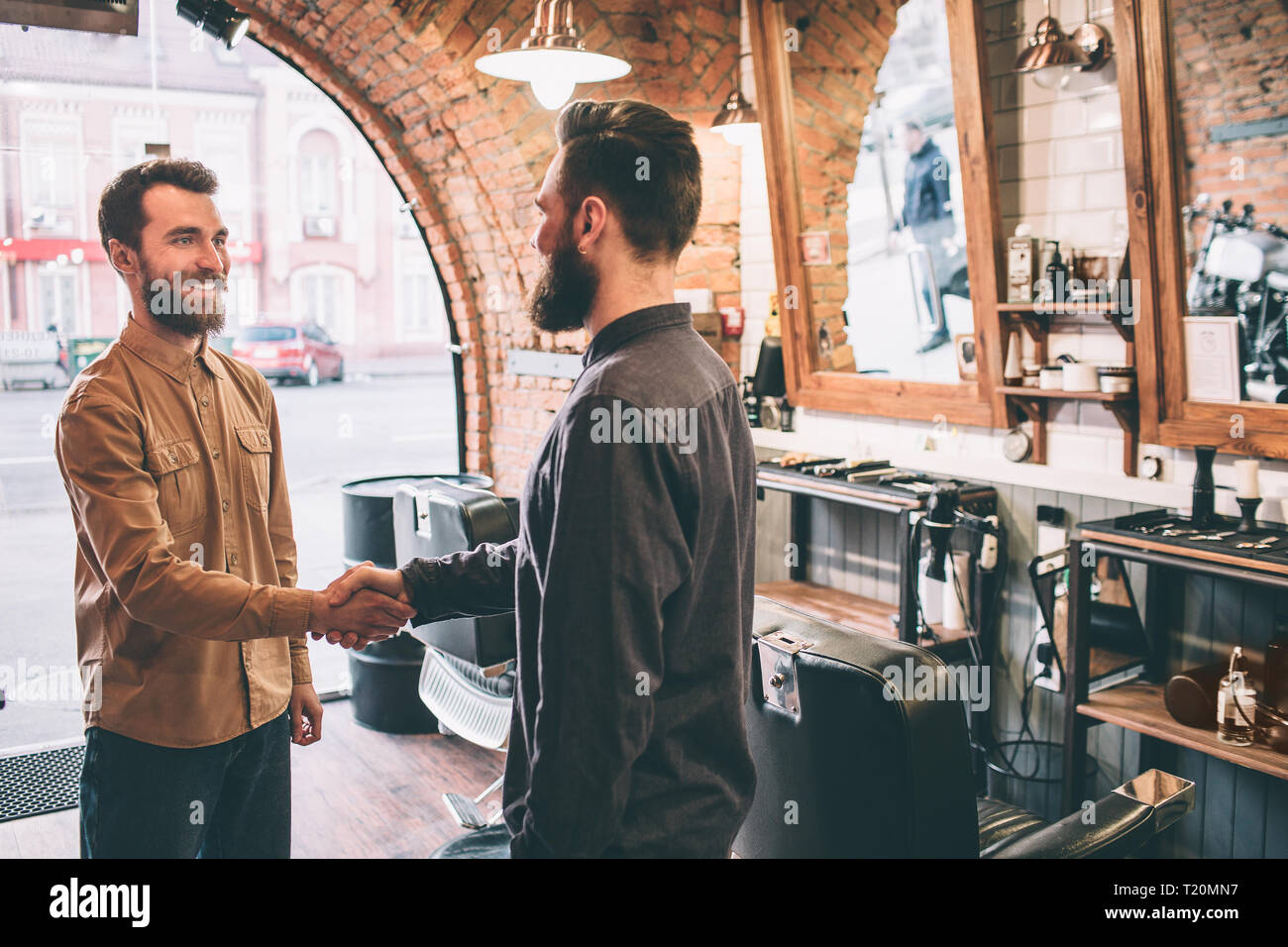 Two friendly guys are shaking each other hands. They liked to work with ...