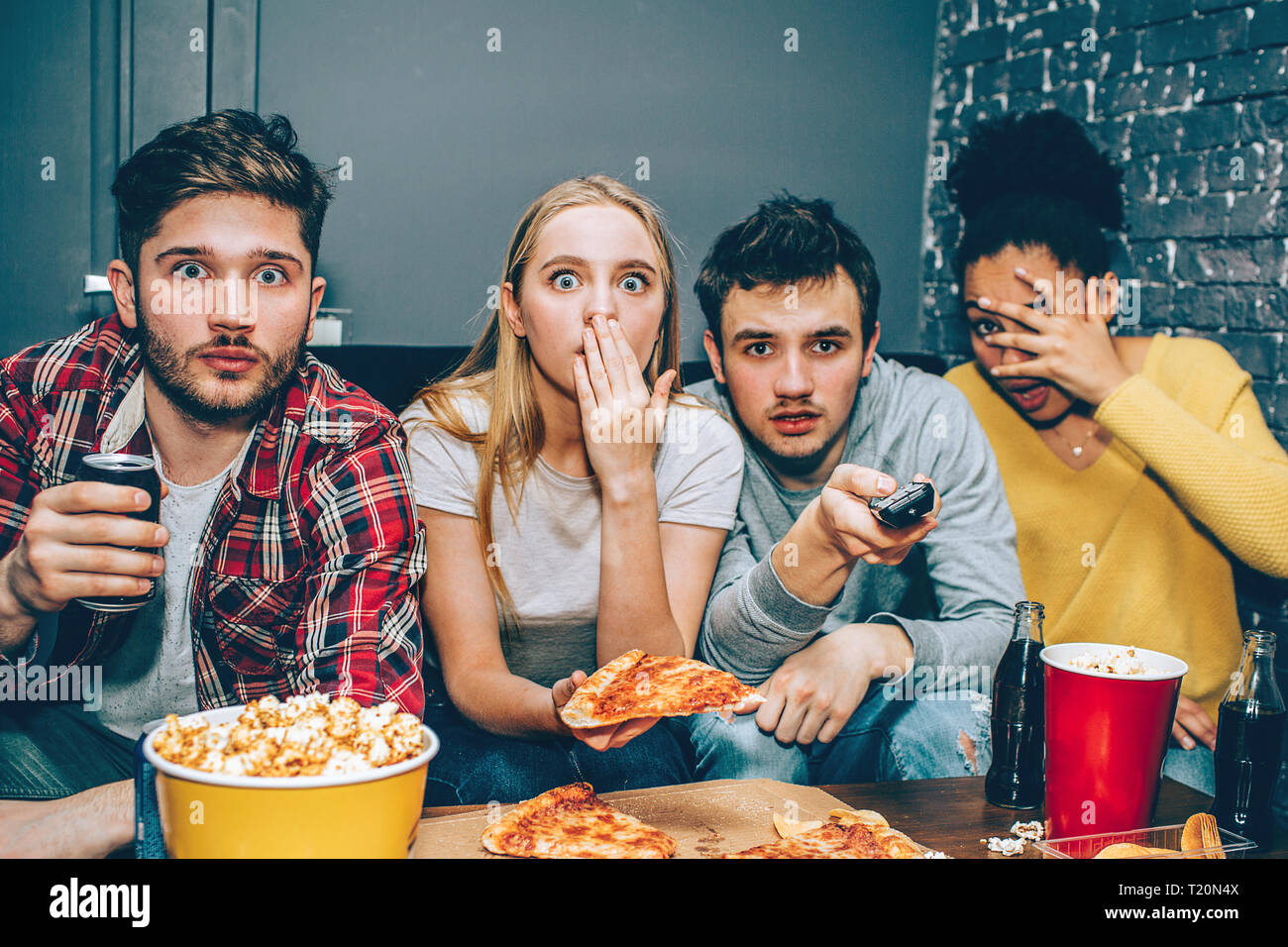 Close up of four people that look very scared and sad. They are ...