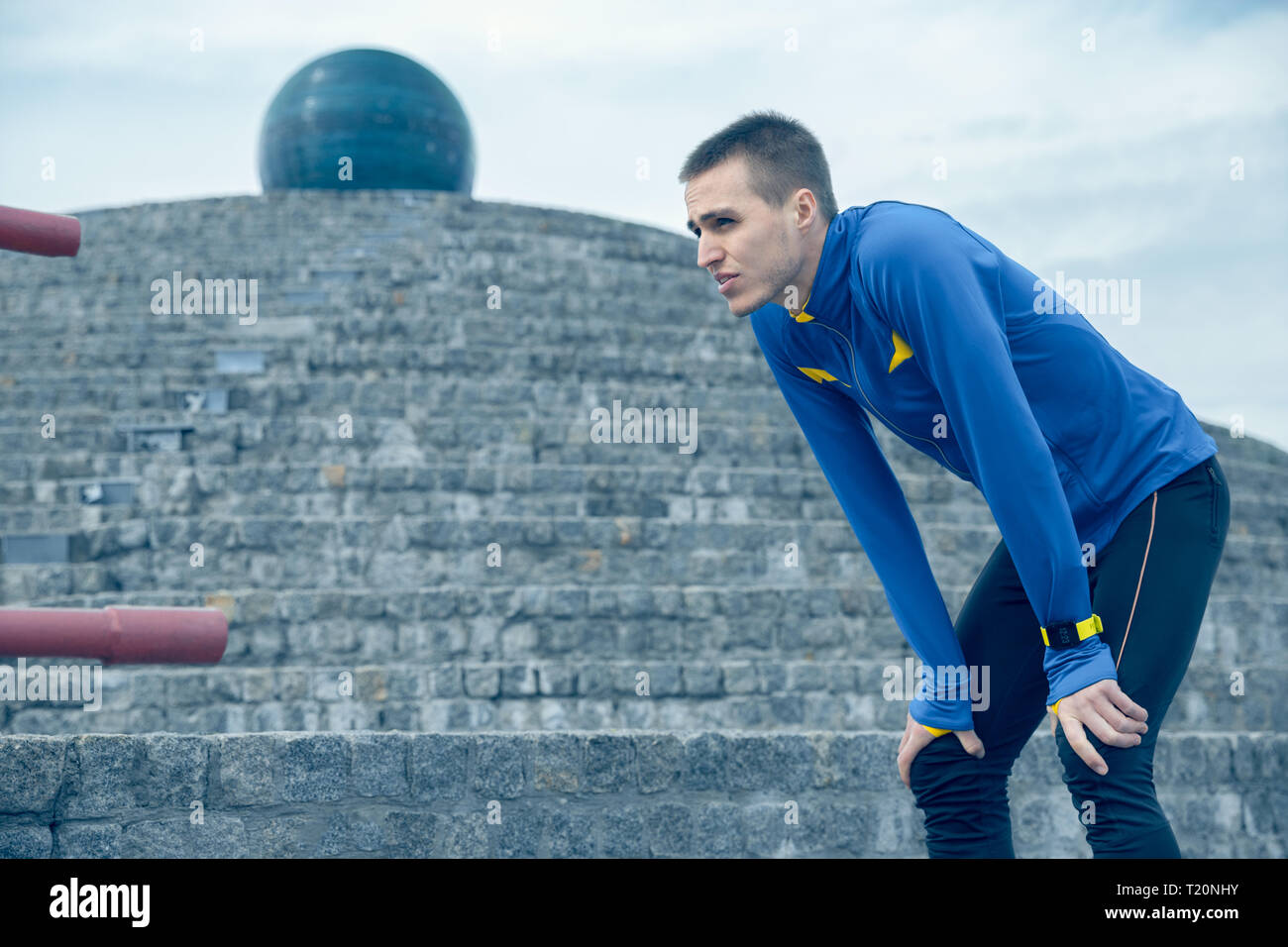 Man resting after running on city background at morning. Healthy ...