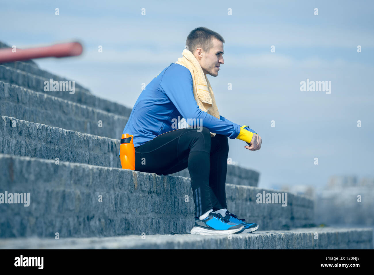 Man resting after running on city background at morning. Healthy ...