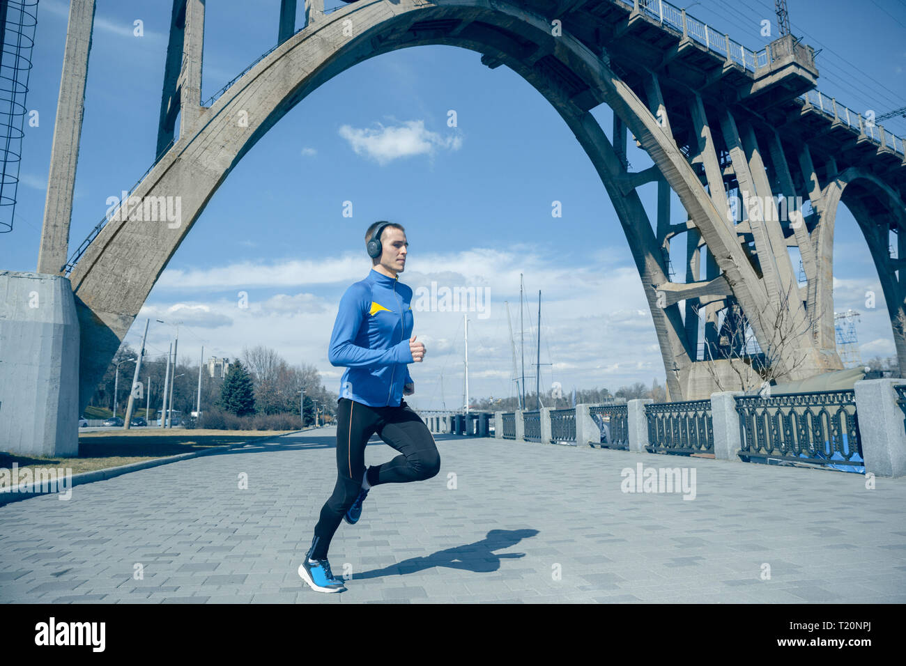 Man running on city background at morning. Healthy lifestyle concept ...