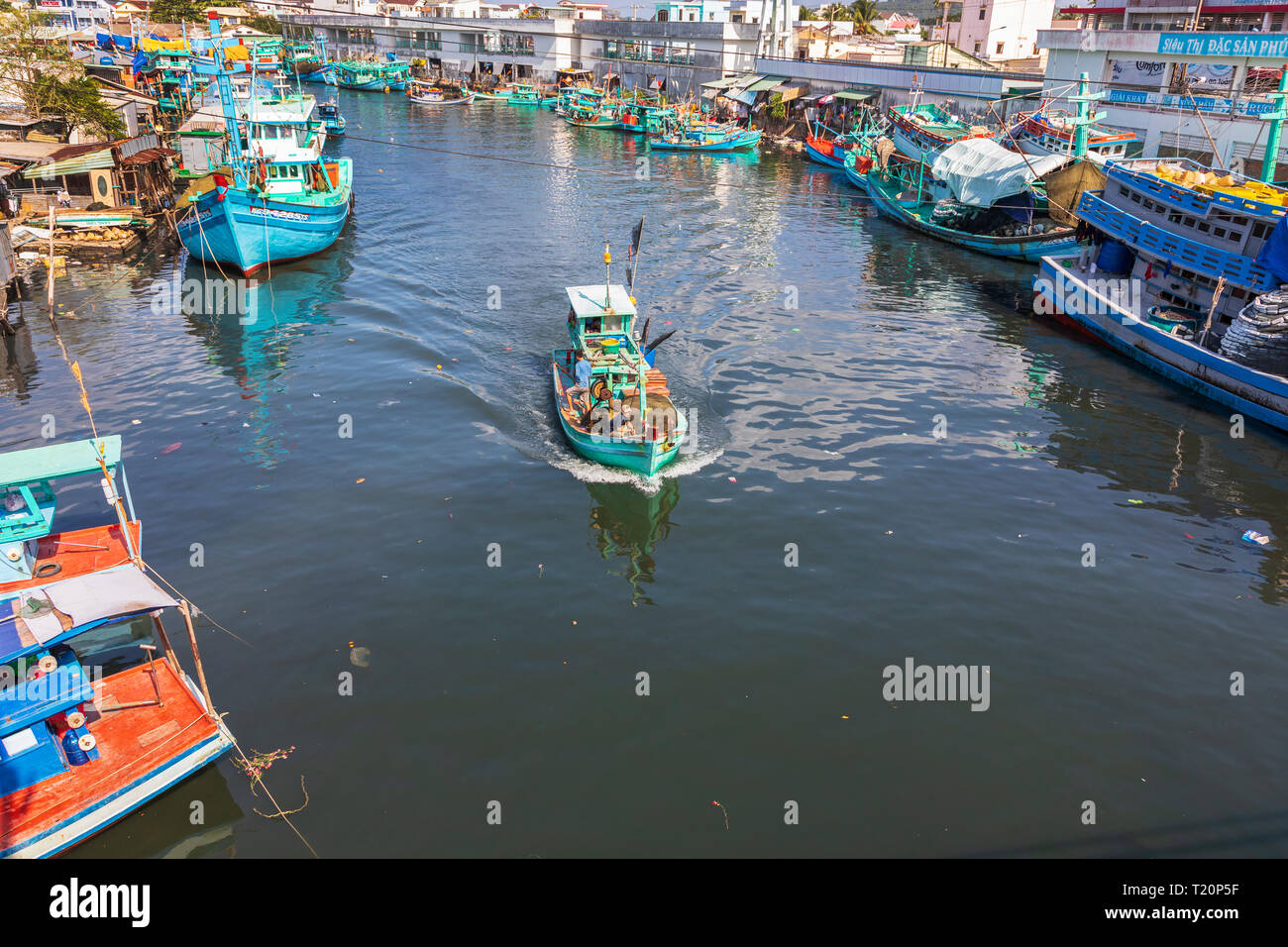 Traditional Vietnamese fishing boats tied up at the harbour at Dinh Cau ...