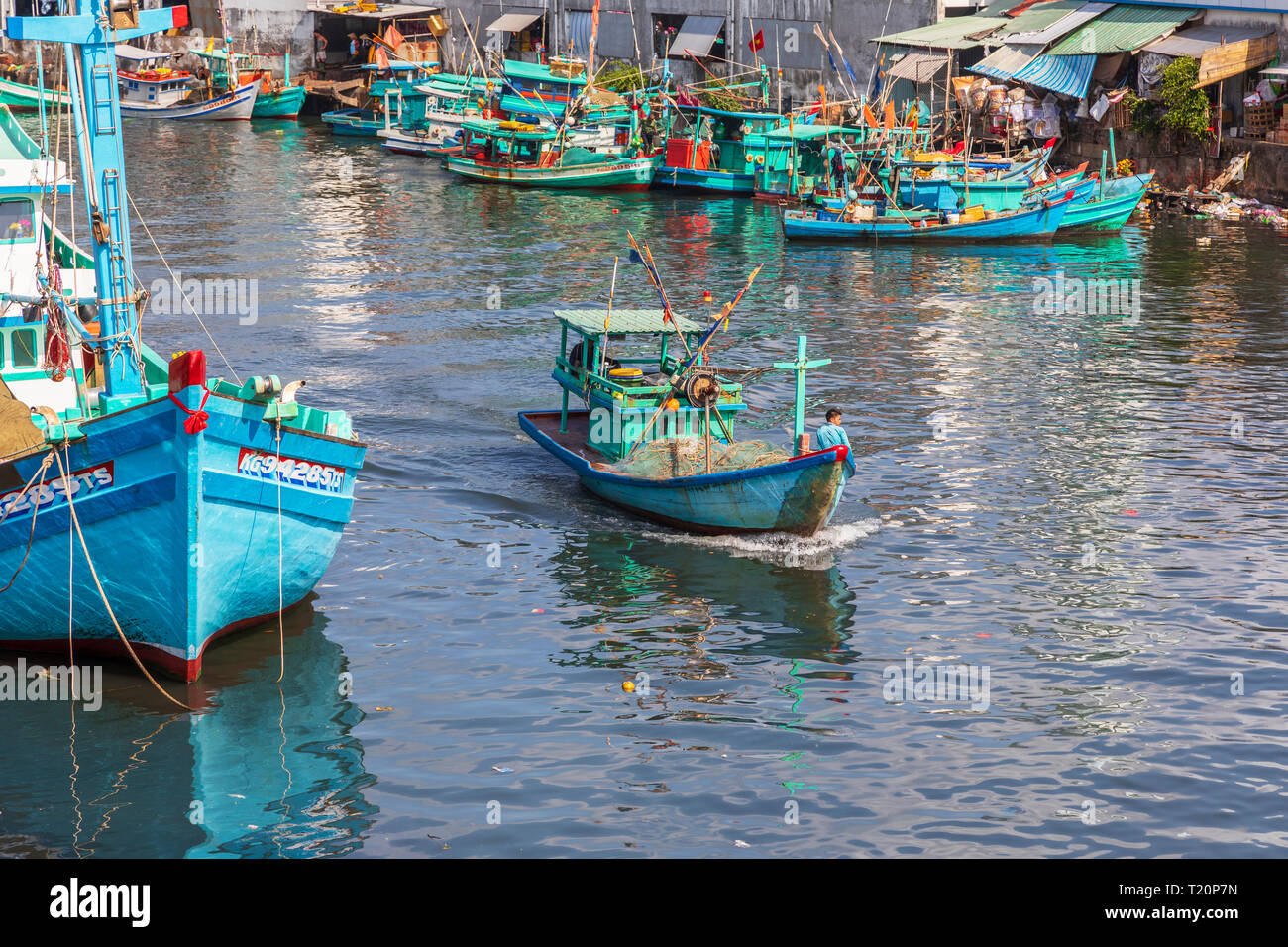 Traditional Vietnamese fishing boats tied up at the harbour at Dinh Cau ...