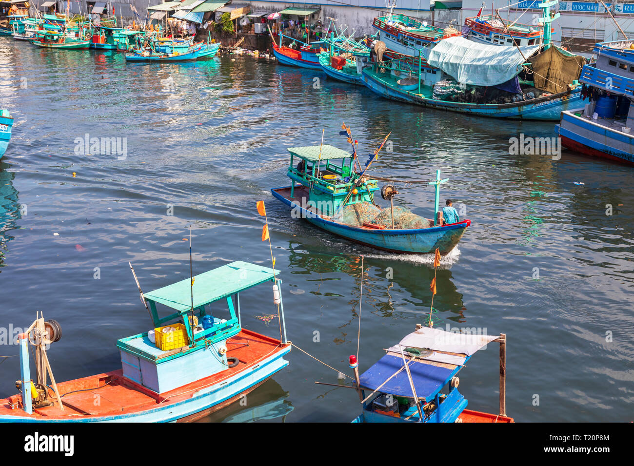 Traditional Vietnamese fishing boats tied up at the harbour at Dinh Cau ...