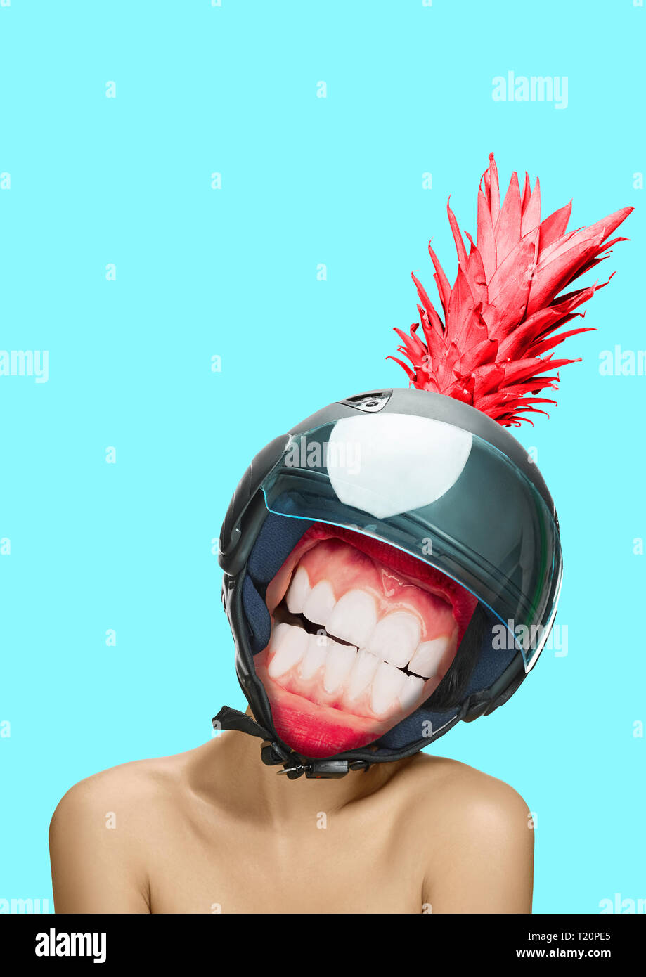 A tough safety. Female head in moto helmet with scratching white teeth ...