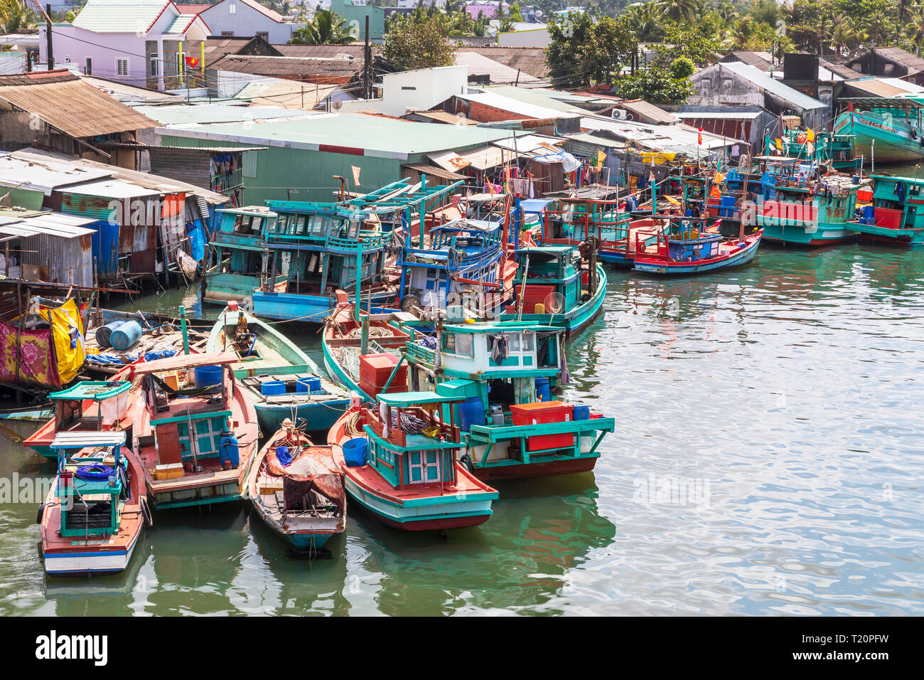 Traditional Vietnamese fishing boats tied up at the harbour at Dinh Cau ...