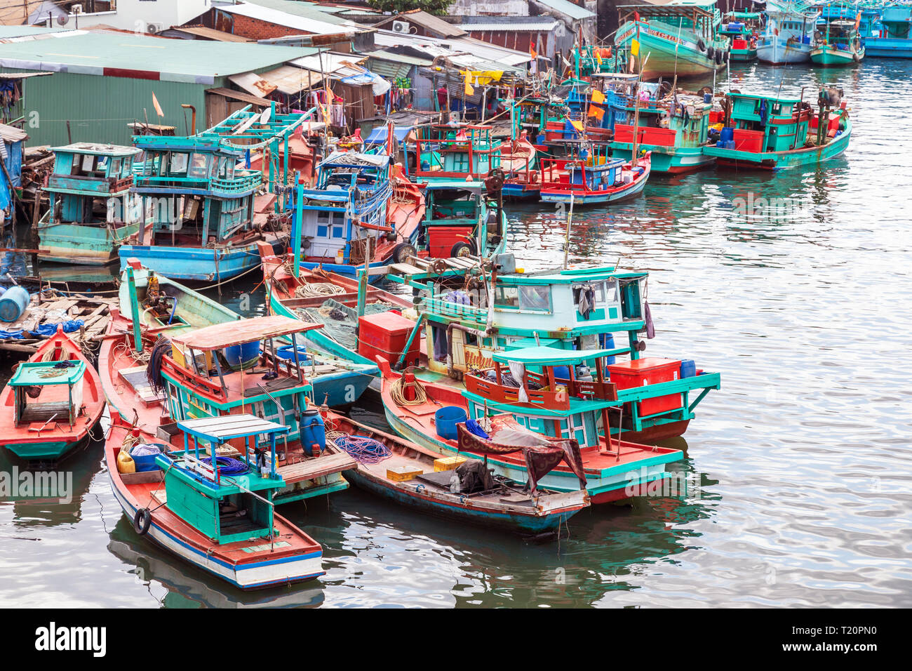 Traditional Vietnamese fishing boats tied up at the harbour at Dinh Cau ...