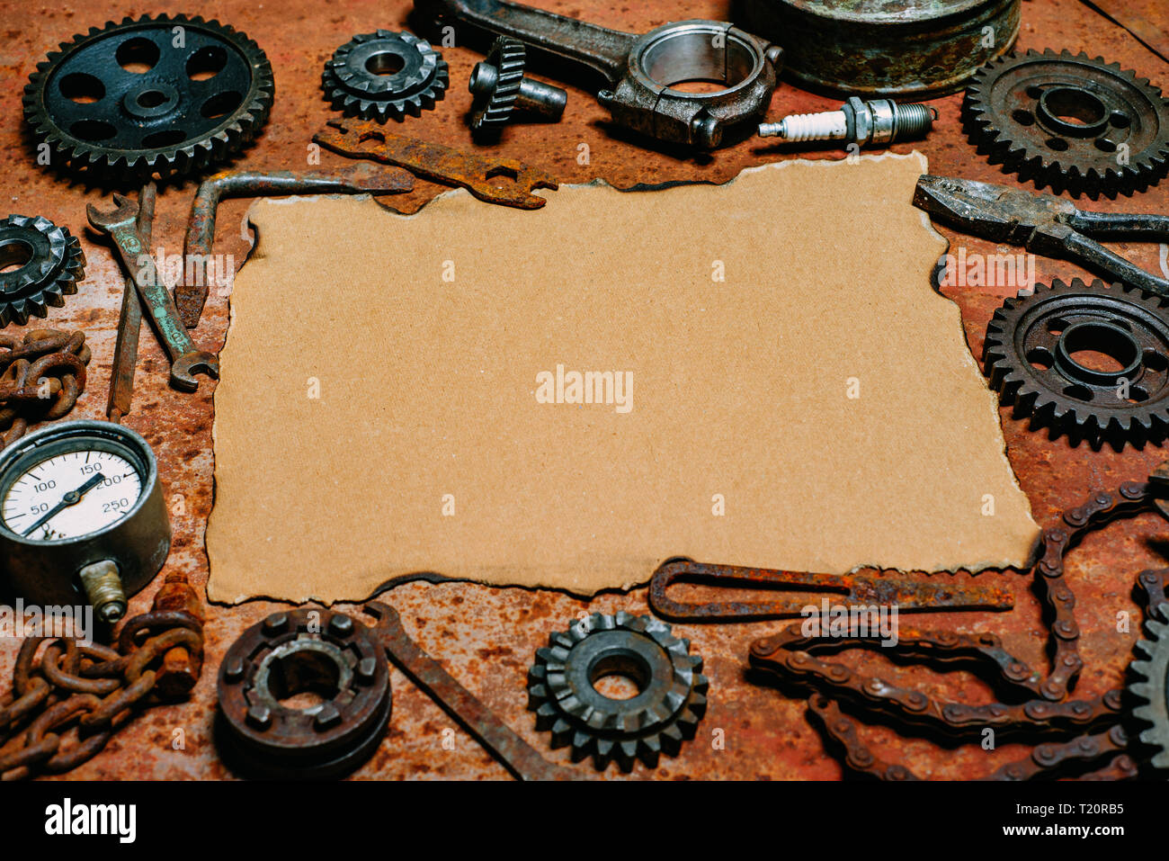Closeup vintage paper in the center of rusty chain, tools on old metal ...