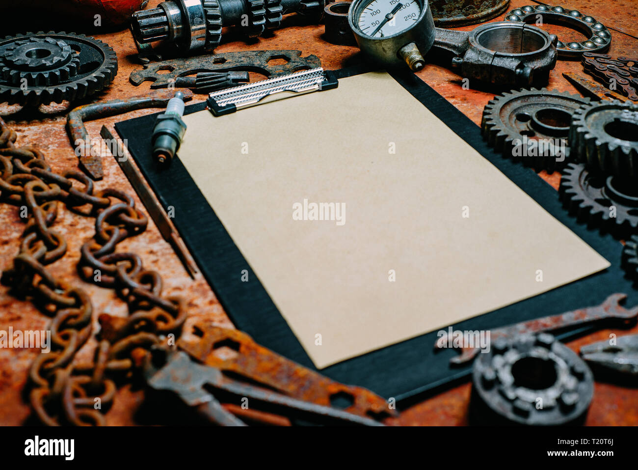 Clipboard with paper in the center of rusty tools, gears on vintage ...