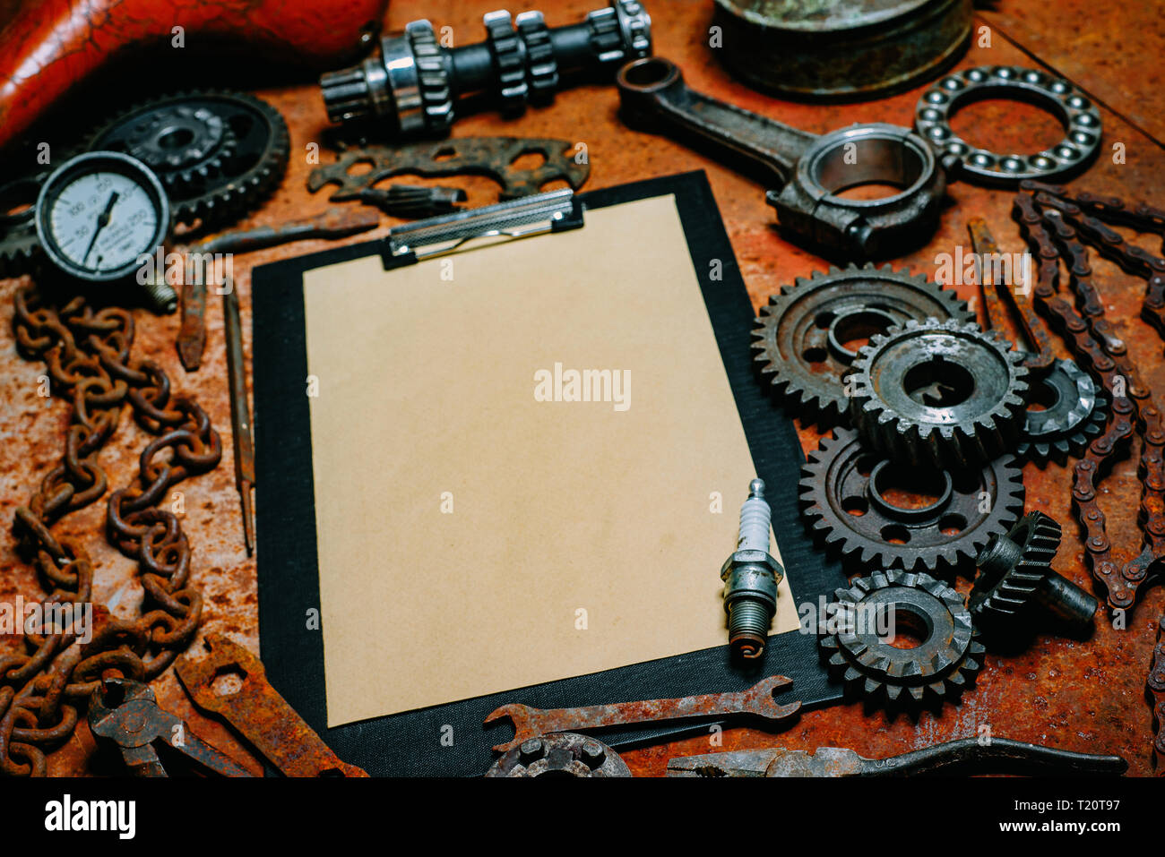 Clipboard with paper in the center of rusty tools, gears on vintage ...