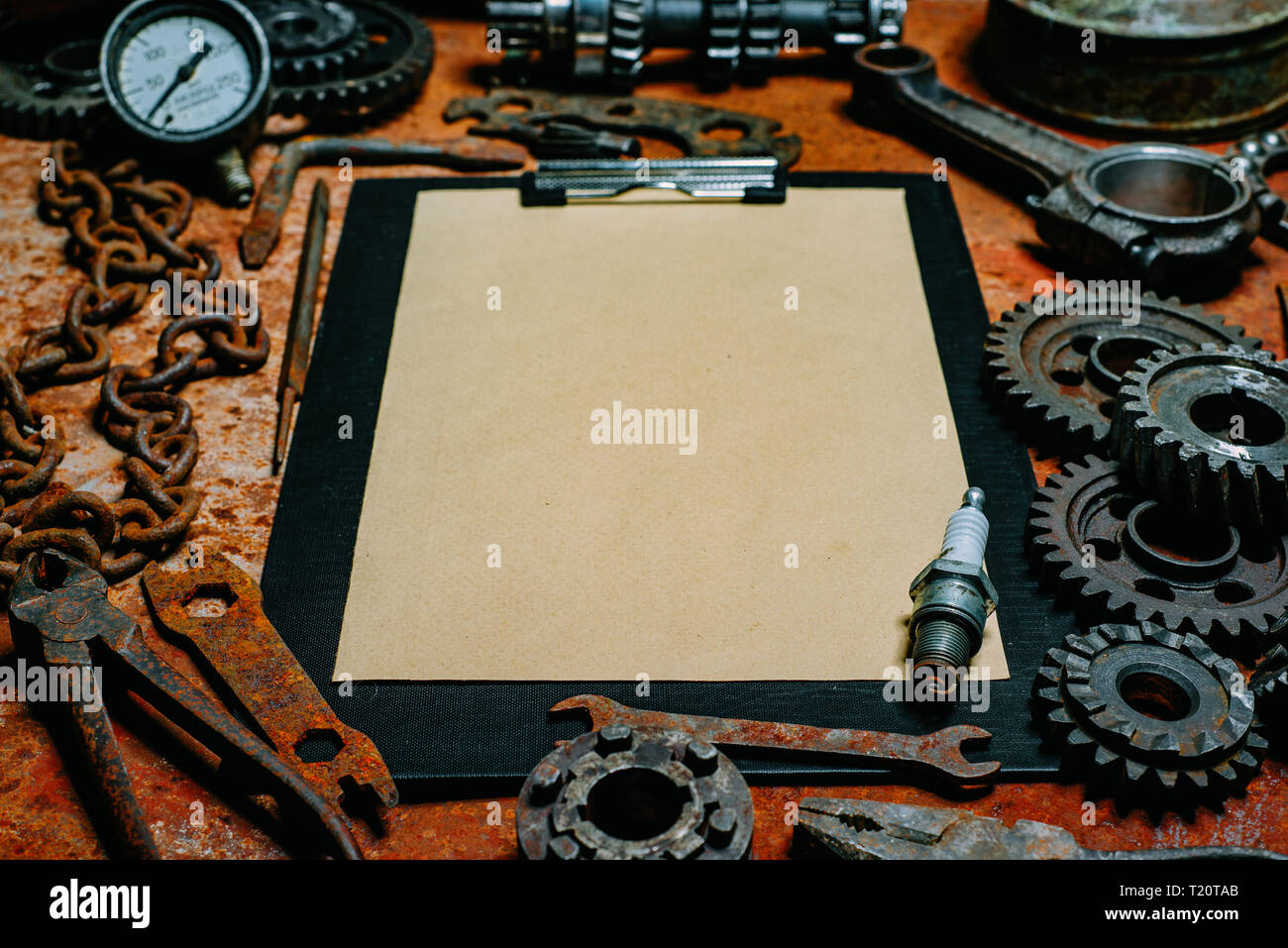Clipboard with paper in the center of rusty tools, gears on vintage ...