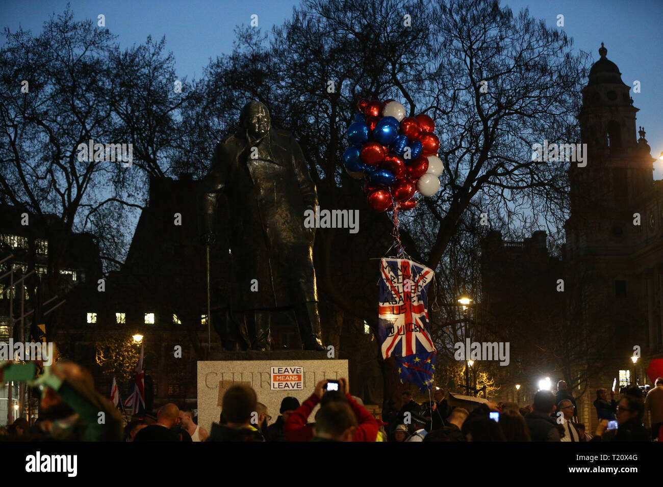 Protesters pass the Winston Churchill statue in Parliament Square ...
