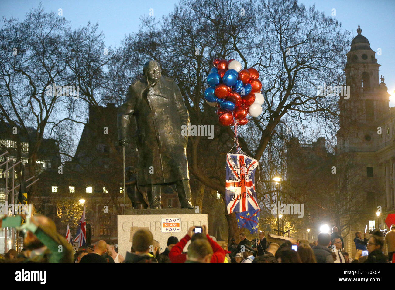 Protesters pass the Winston Churchill statue in Parliament Square ...