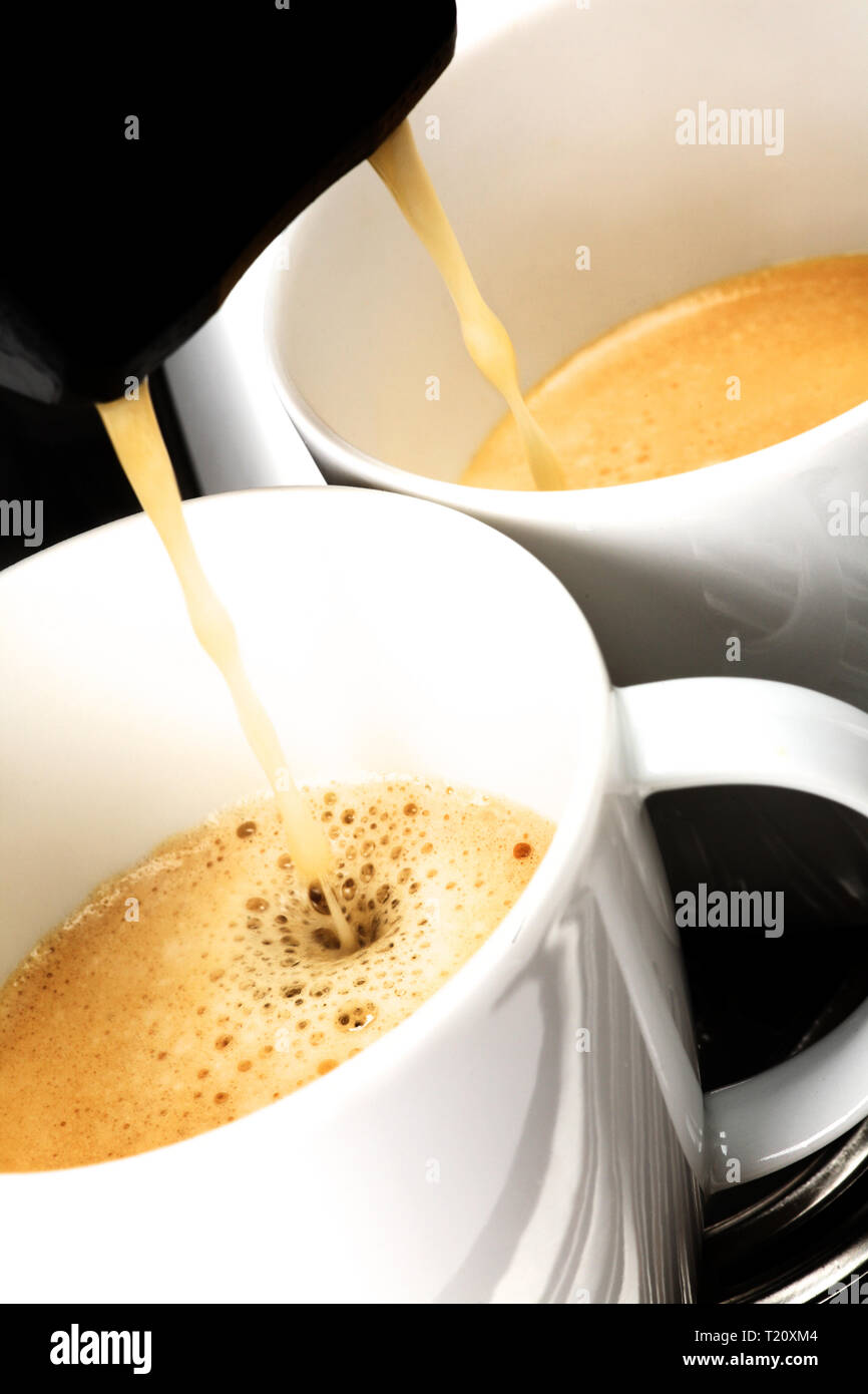 Coffee preparation with a pad machine. Two cups are filled ...
