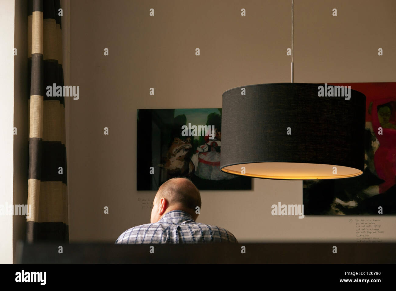 Seated man in a hotel lounge looking out of window Stock Photo - Alamy